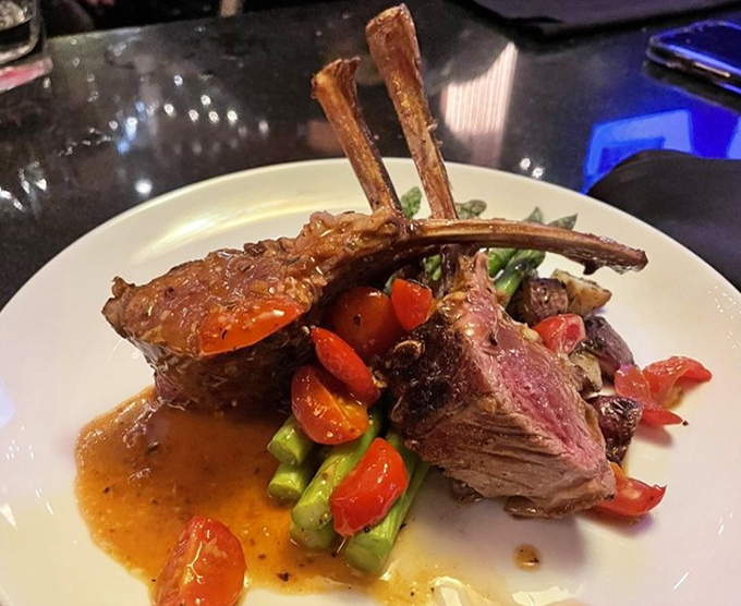 Behold the rack of lamb&mdash;perfectly pink, expertly frenched, and surrounded by colorful vegetables. This is food that makes you want to applaud.