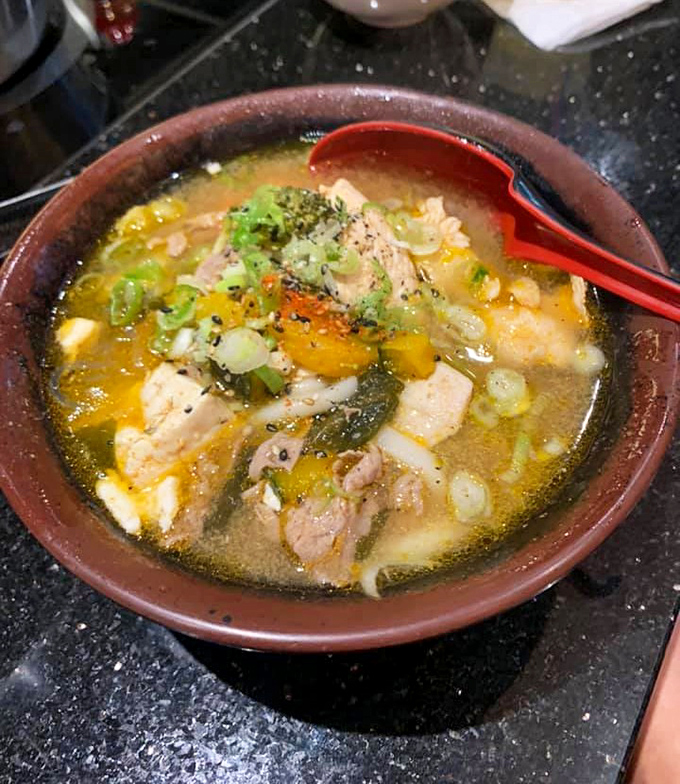 This isn't just ramen—it's a symphony of flavors where each ingredient plays its part perfectly in a broth-turned-masterpiece.