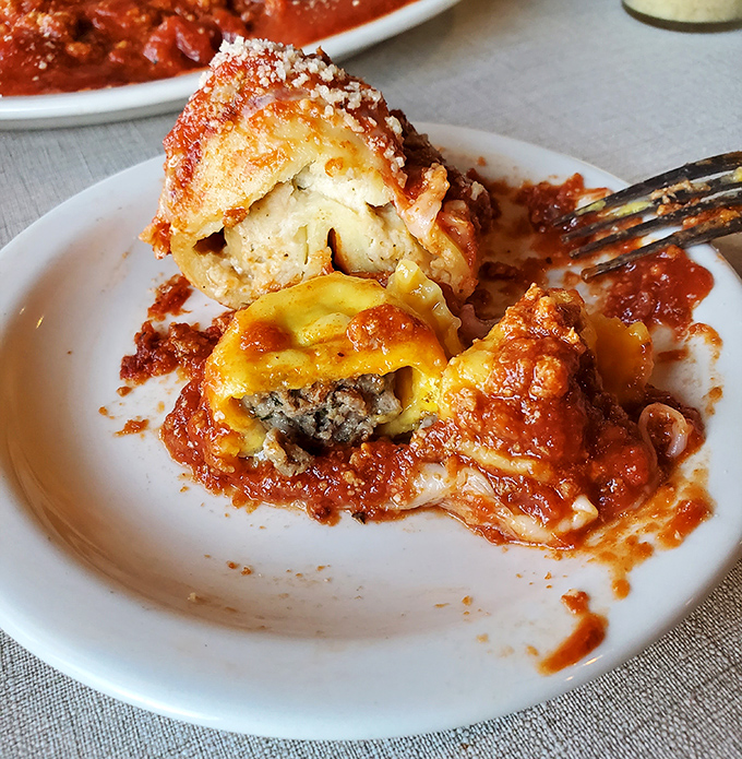 Behold the portabella ravioli in all its glory—pasta pillows stuffed with earthy mushrooms and bathed in that remarkable red sauce. This is what dreams are made of.
