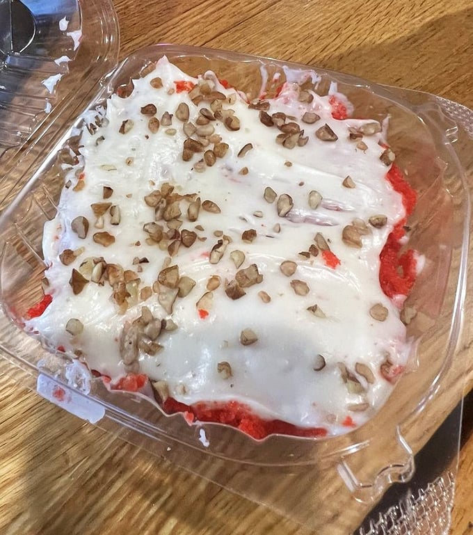 The legendary red velvet cake in its natural habitat. Those pecans on top aren't just garnish&mdash;they're the crown jewels.