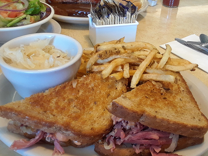 The Reuben isn't just a sandwich here; it's an architectural marvel of perfectly balanced corned beef, sauerkraut, and Swiss that demands a two-handed commitment.
