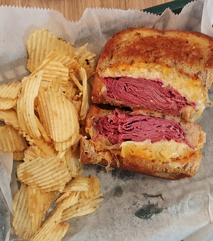 Behold the star attraction: layers of rosy corned beef nestled between golden rye, with sauerkraut and Swiss playing their supporting roles to perfection.