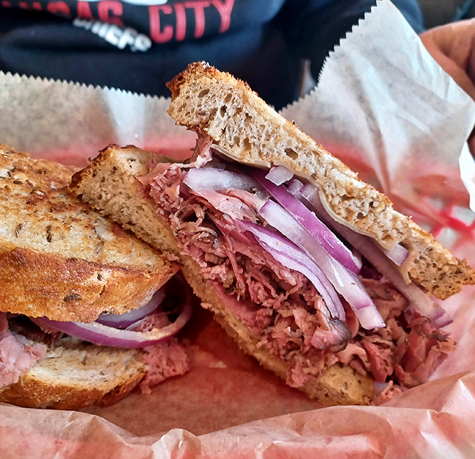 Behold the architectural marvel that is a proper deli sandwich. Layers of thinly-sliced meat, the sharp bite of onion, all between perfectly grilled rye.