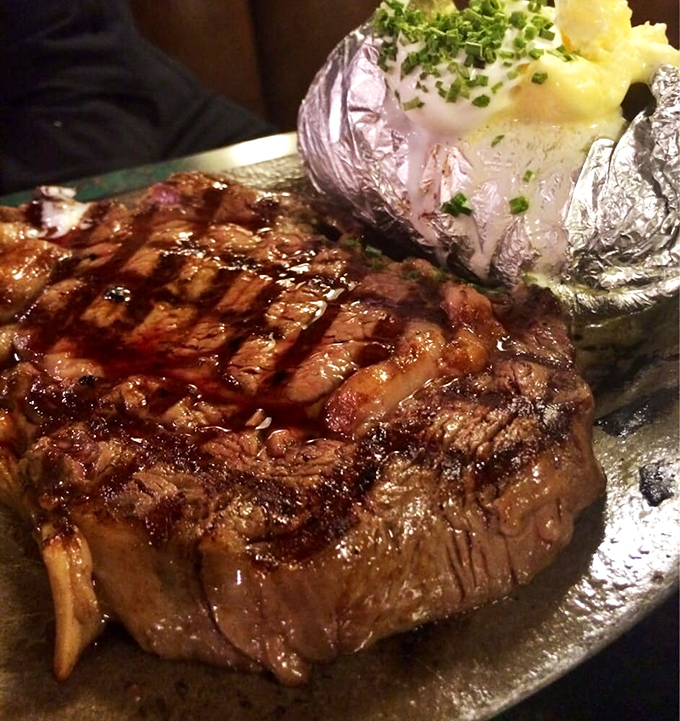This isn't just a steak; it's a masterpiece of marbling and char, accompanied by a loaded baked potato that's practically begging for a close-up.