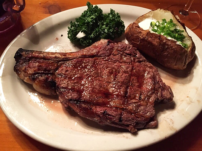 Behold the ribeye in its natural habitat&mdash;perfectly charred, gloriously juicy, and flanked by its loyal companions: a loaded baked potato and token green vegetable.