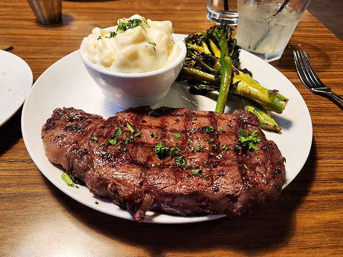 Behold the ribeye in its natural habitat&mdash;perfectly seared, resting beside creamy mashed potatoes and grilled asparagus. Poetry on a plate.