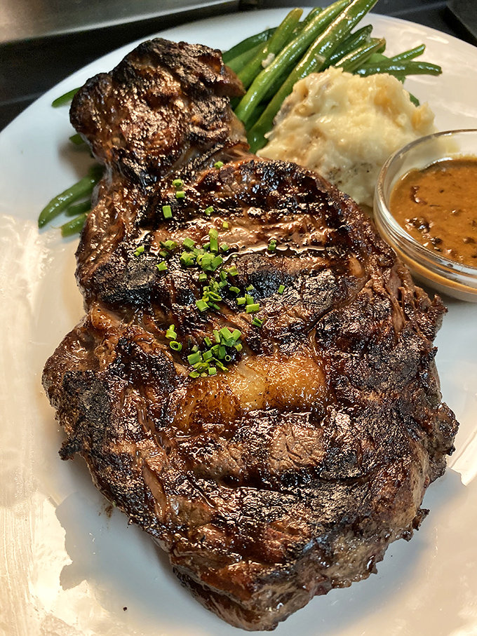 This ribeye isn't just cooked—it's been transformed into a carnivore's sonnet, complete with that perfect char that whispers "worth every calorie."