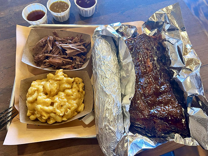 Behold: ribs with that perfect pink smoke ring, mac and cheese that could make a southerner weep, and pulled pork that practically dissolves on contact.