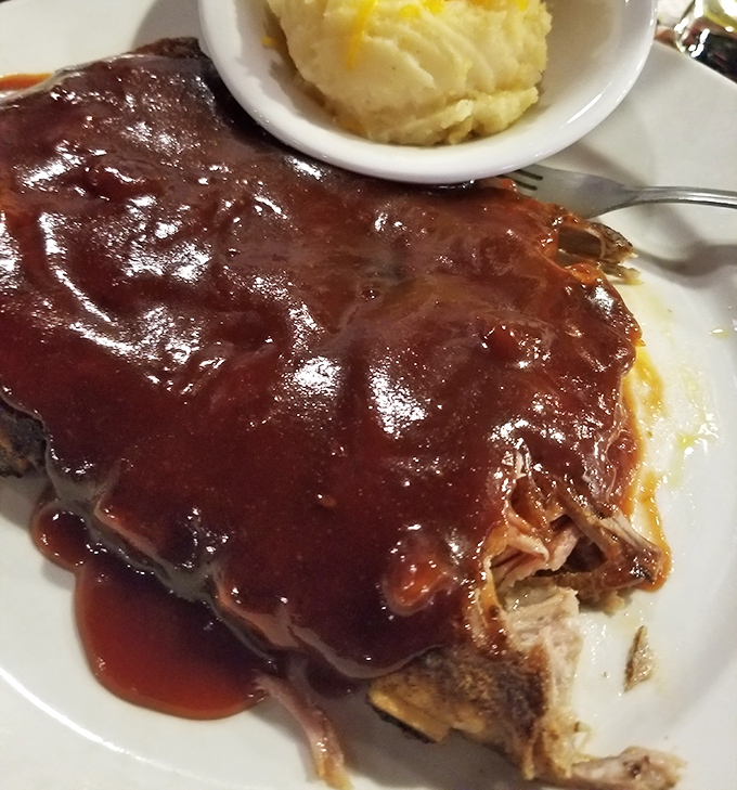 These ribs aren't just falling off the bone&mdash;they're practically volunteering to jump onto your fork. The glossy sauce creates a beautiful mahogany finish that's practically artwork.