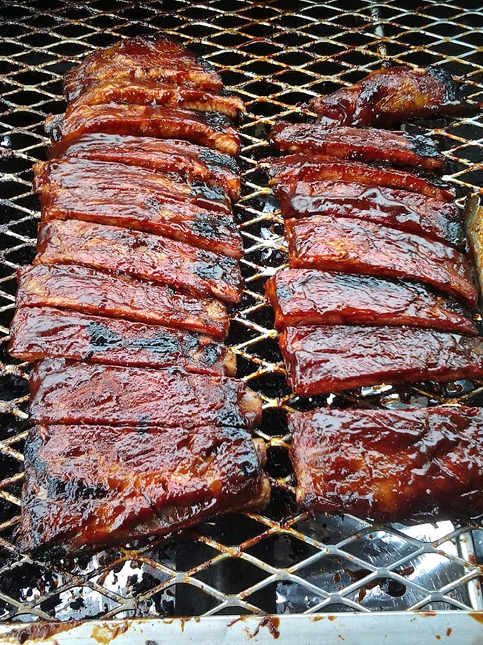 These ribs aren't just cooked; they're coaxed into tenderness through a slow dance of smoke and time. That glaze isn't sauce&mdash;it's edible stained glass.