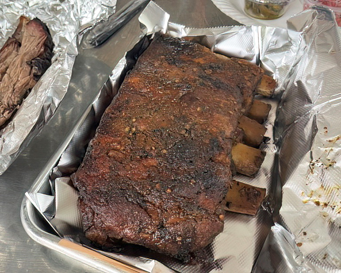 Behold the holy grail of BBQ &ndash; perfectly smoked ribs with that coveted pink smoke ring and bark that would make a tree jealous. Napkins required, no apologies necessary.