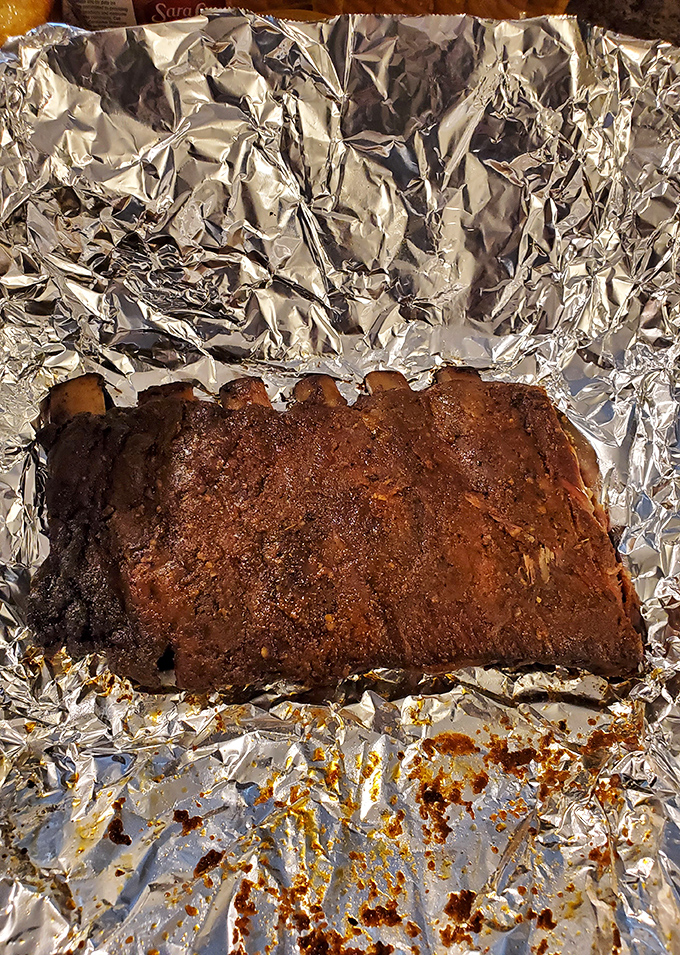 These ribs aren't just smoked; they're transformed into something transcendent. That bark, that color&mdash;this is what barbecue dreams are made of.