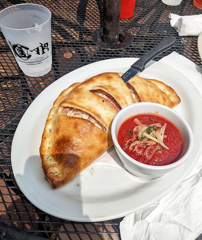 The calzone that launched a thousand cravings &ndash; golden-brown perfection with marinara so vibrant it deserves its own Instagram account.
