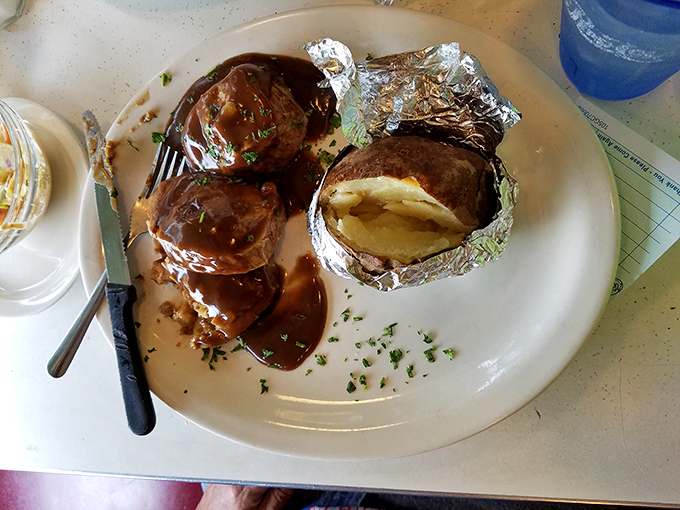 Behold the star attraction – roast beef so tender it surrenders to your fork, swimming in gravy that should be classified as a controlled substance.