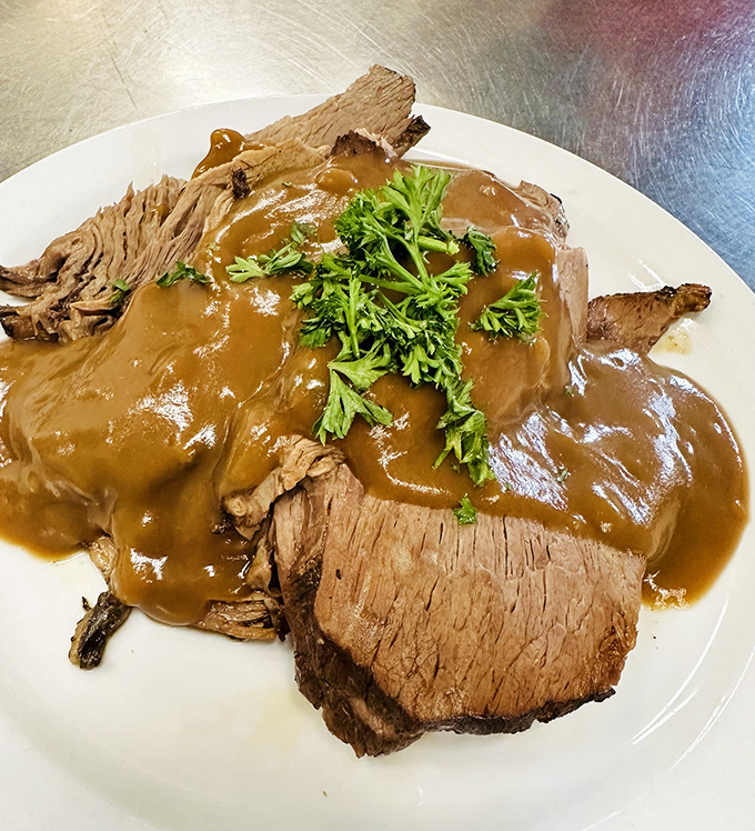 Behold the star pupil: roast beef so tender it practically dissolves on contact, swimming in gravy that deserves its own diploma.