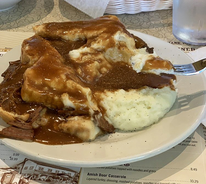 Behold the star attraction: roast beef so tender it practically surrenders to your fork, swimming in gravy that should be classified as a controlled substance. 