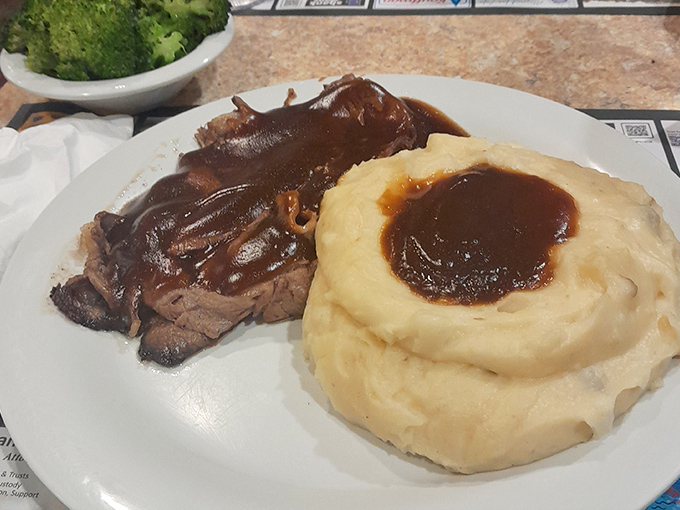 Behold the roast beef that launched a thousand road trips, swimming in gravy that deserves its own zip code.