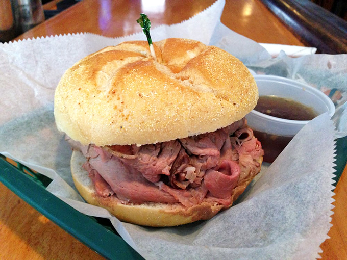 The star of the show in all its glory &ndash; hand-carved roast beef piled high on a perfect roll with au jus standing by for dunking duty.