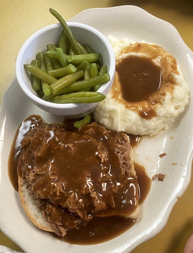 This isn't just roast beef &ndash; it's a tender masterpiece swimming in gravy that would make your grandmother weep with pride. The mashed potatoes create the perfect gravy lake.