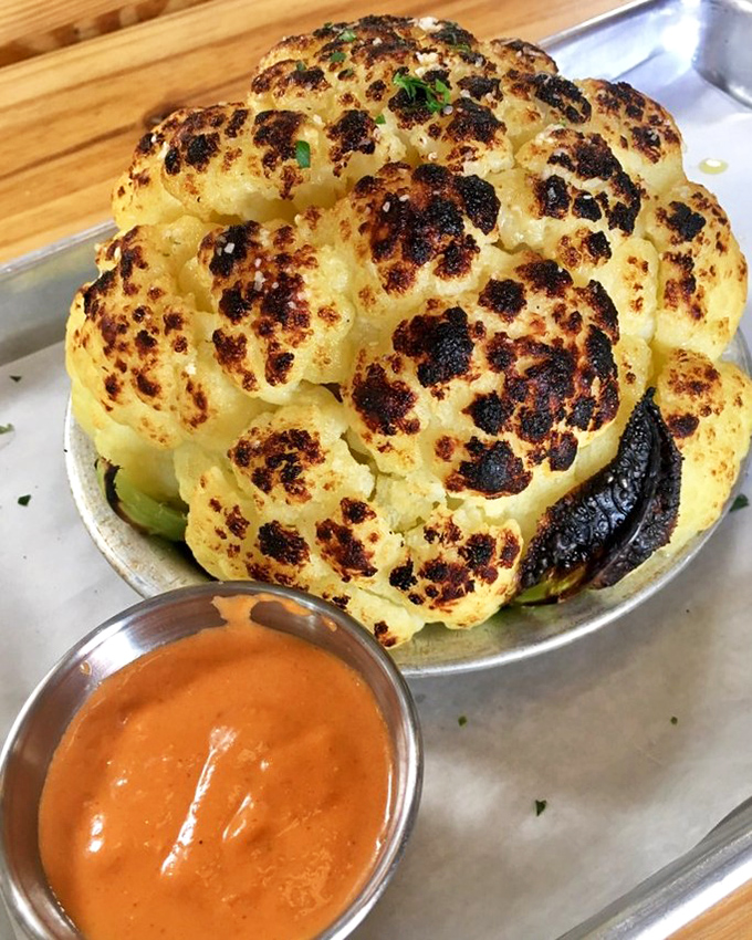 Behold the cauliflower that launched a thousand return visits&mdash;charred to perfection and served with a sauce that makes vegetables feel like an indulgence, not a obligation.