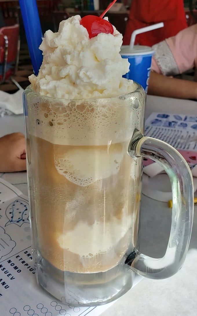 The legendary root beer float arrives like a frothy masterpiece. That perfect moment when ice cream meets soda &ndash; childhood bliss in a frosted mug.