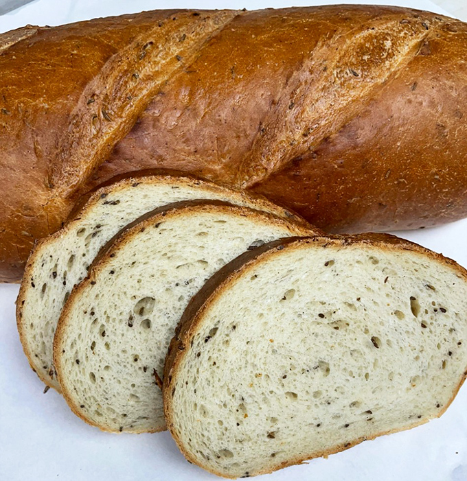 This isn't just bread; it's a caraway-studded masterpiece with a crust that snaps and an interior that yields &ndash; the foundation of sandwich greatness.