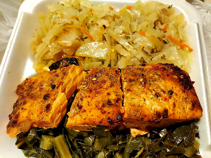 This salmon platter isn't just dinner&mdash;it's edible poetry. Perfectly seasoned fish nestled between cabbage and collard greens creates a harmony of flavors that sings.
