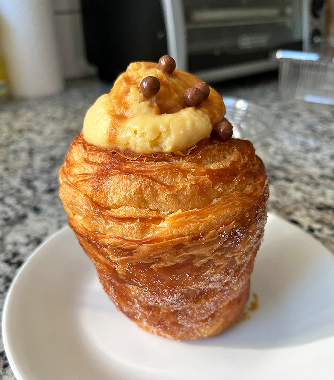 This isn't just a cruffin—it's architecture, art, and pure indulgence stacked into a golden tower of caramel-topped perfection. Resistance is futile.