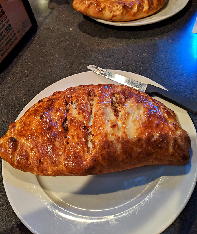 Behold the legendary sausage roll in all its golden-brown glory. That perfect crust harbors treasures of sausage and cheese that would make Italian grandmothers nod in approval.