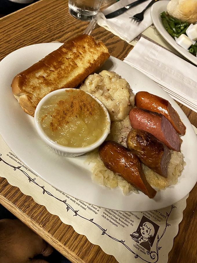Sausages nestled on sauerkraut like meaty jewels on a tangy throne. This plate doesn't just satisfy hunger&mdash;it creates lifelong memories and possibly a nap afterward.