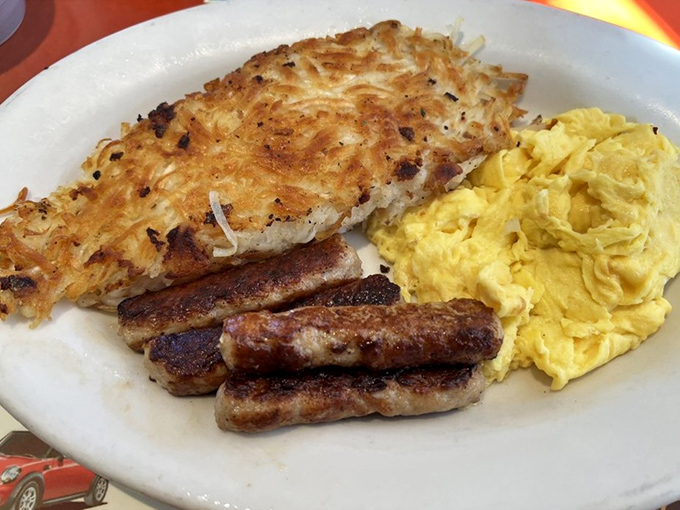 Golden hash browns that crunch like autumn leaves, perfectly scrambled eggs, and sausage links that snap with each bite.