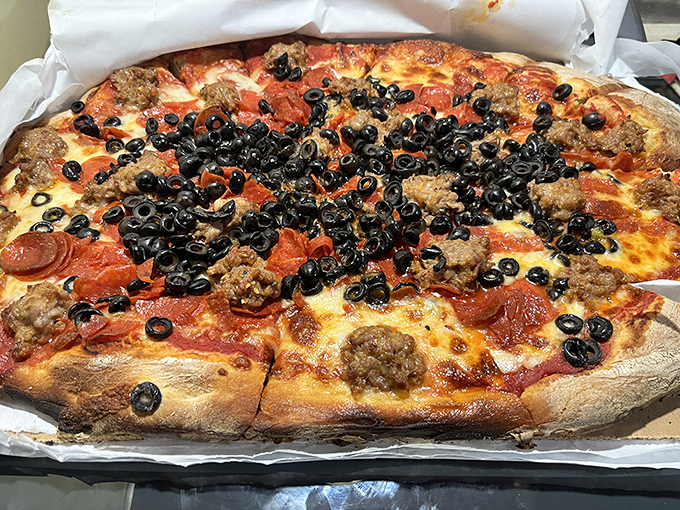 This isn't just a pizza with black olives&mdash;it's a declaration of abundance. Every topping fights for real estate on this magnificent pie.