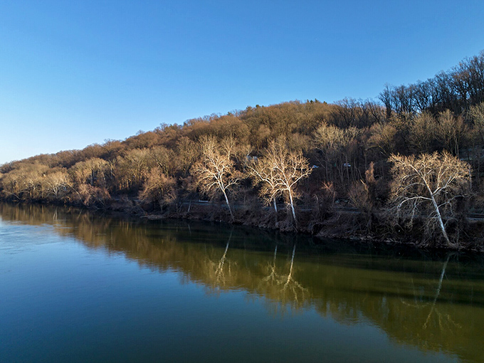 The Schuylkill River flows like a liquid timeline, reflecting bare winter trees that have witnessed centuries of Conshohocken's changing fortunes.