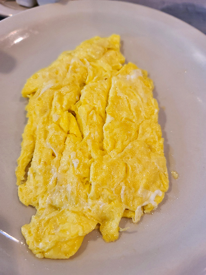 Sunshine on a plate! These cloud-like scrambled eggs achieve that perfect balance of fluffy and substantial&mdash;the diner holy grail.