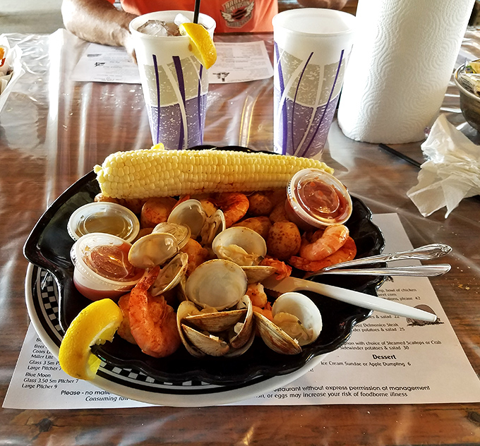 This seafood sampler isn't just dinner; it's a maritime celebration with clams, shrimp, and corn playing the starring roles.