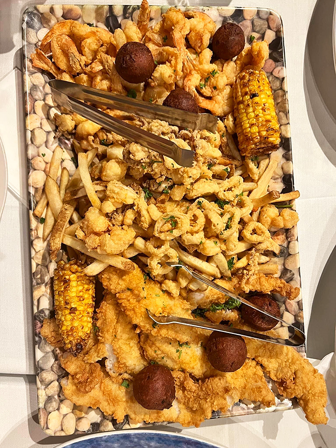 This seafood platter isn't just dinner&mdash;it's an edible work of art featuring golden-fried treasures from the deep, complete with hush puppies and grilled corn.
