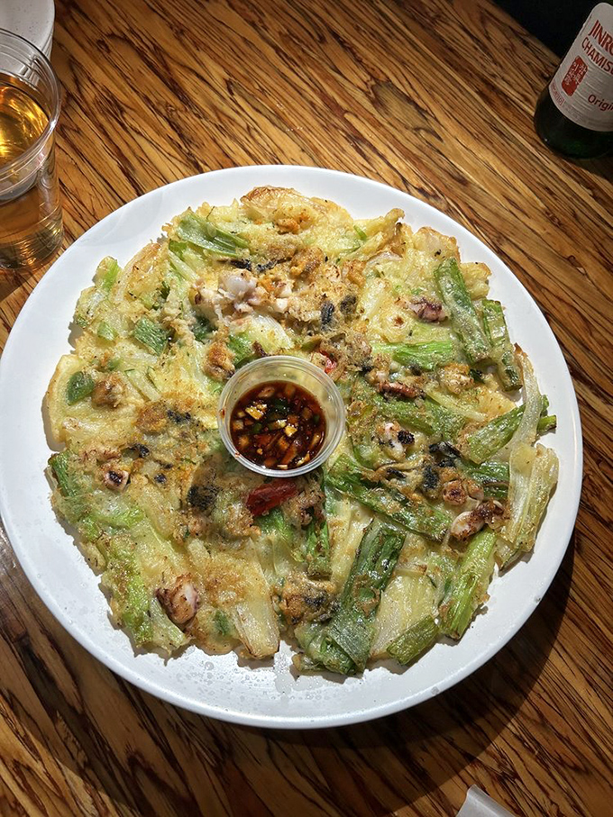 Behold the haemul pajeon in all its glory! Crispy exterior, tender seafood treasures within &ndash; this pancake doesn't need maple syrup, just your undivided attention.