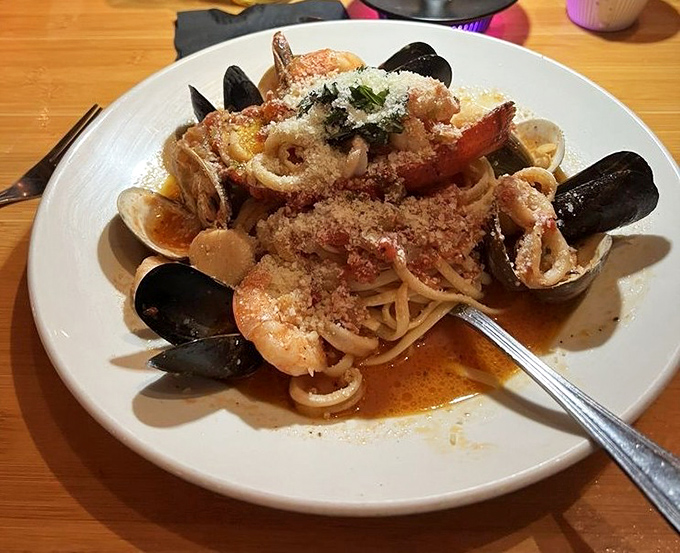Behold the legendary Seafood Pescatore – a mountain of oceanic treasures atop perfectly cooked linguine. The fork marks the beginning of a beautiful friendship.