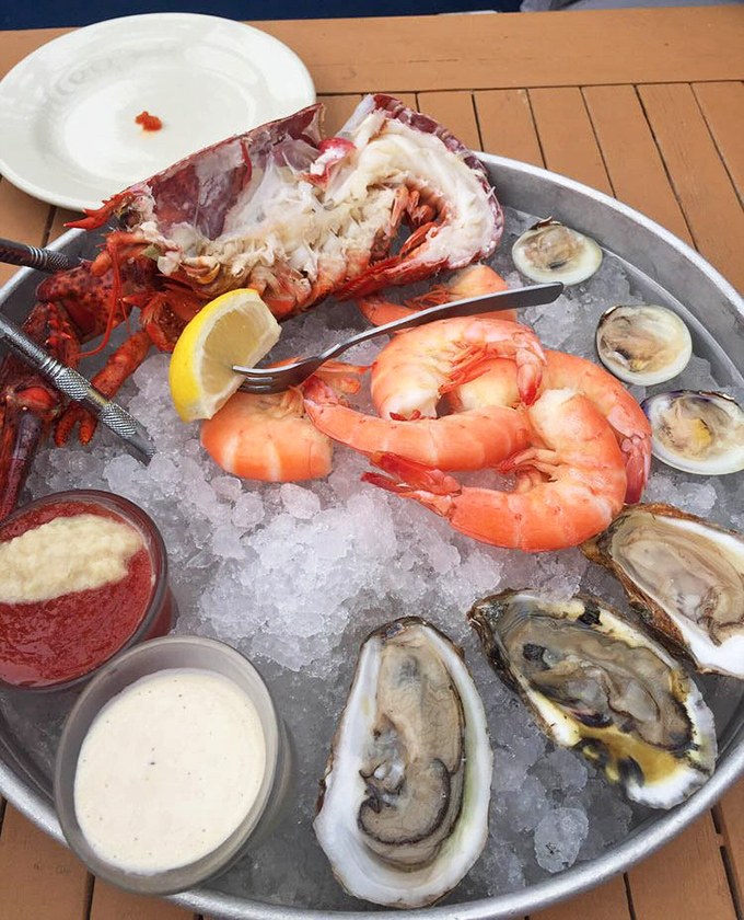 Behold the seafood tower of dreams: fresh lobster, plump shrimp, and briny oysters arranged like oceanic jewelry.