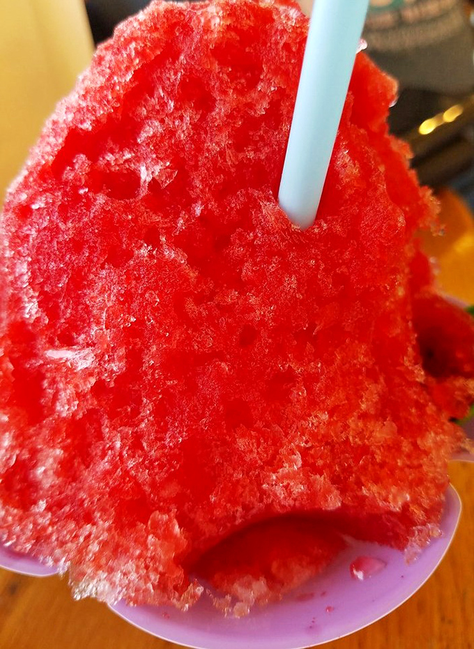 This shaved ice isn't just dessert—it's a crimson mountain of nostalgia that melts away adult problems with each spoonful.
