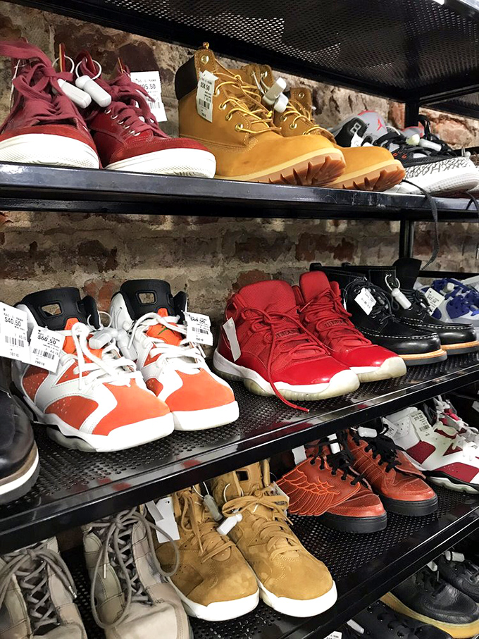 Designer sneakers and boots huddle together on shelves, waiting patiently for their next walking adventure stories.