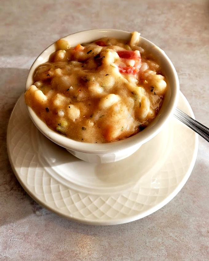 The legendary shrimp bisque arrives like a warm hug in a bowl—chunks of seafood swimming in creamy perfection that would make Neptune himself weep with joy.