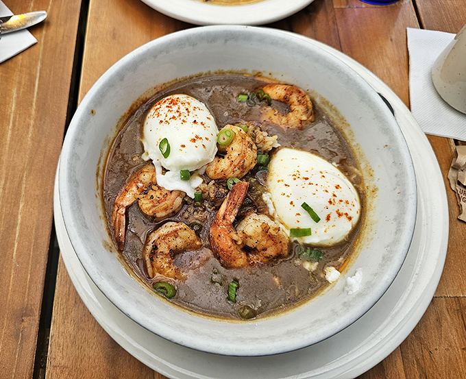 Behold the legendary shrimp and grits &ndash; plump shrimp nestled in creamy grits with poached eggs that ooze golden perfection when pierced.