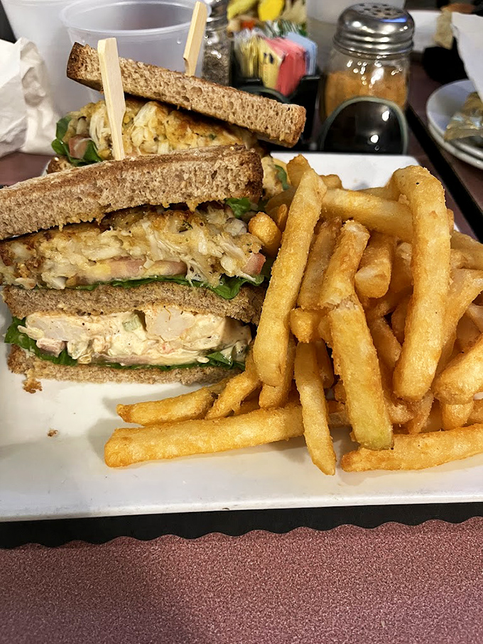A sandwich that belongs in the Seafood Hall of Fame &ndash; golden shrimp salad piled high between toasted bread with crispy fries standing guard.
