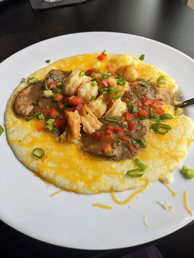 Shrimp and grits that would make your Southern grandmother weep with joy. Creamy, cheesy perfection crowned with plump shrimp and fresh vegetables.