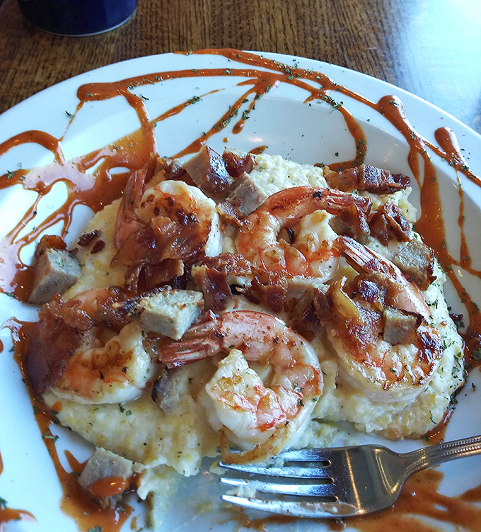 Behold the legendary shrimp and grits in all its glory! Those plump shrimp and creamy grits with bacon crumbles are what breakfast dreams are made of.