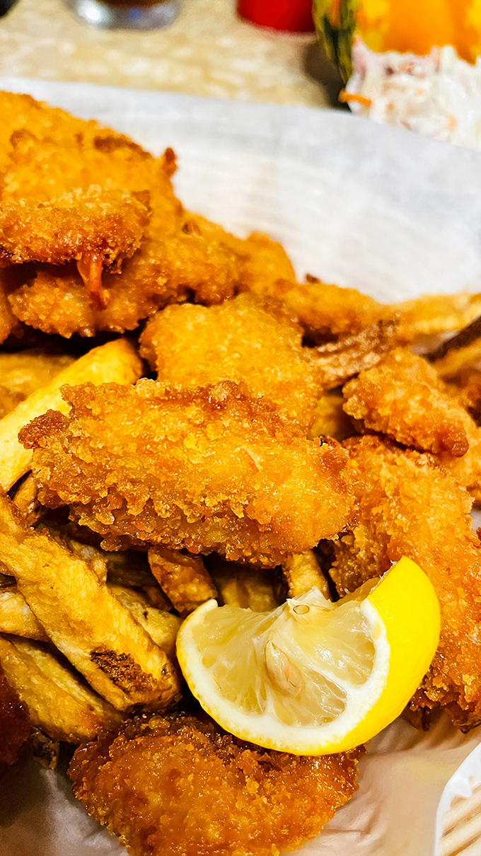 Golden-battered shrimp that crunch like autumn leaves, nestled beside hand-cut fries. The lemon wedge isn't decoration &ndash; it's essential artillery for your taste buds.