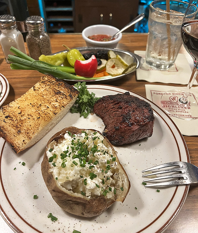 Behold the holy trinity of steakhouse perfection: a perfectly charred sirloin, a loaded baked potato, and that garlic bread that haunts your dreams long after dinner's done.