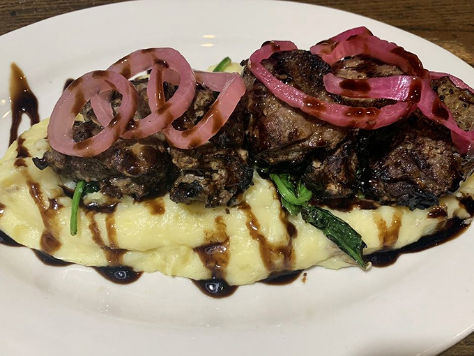 The sirloin tips&mdash;oh my!&mdash;resting on a cloud of mashed potatoes with those pickled red onions adding that perfect zing. Food architecture at its finest.