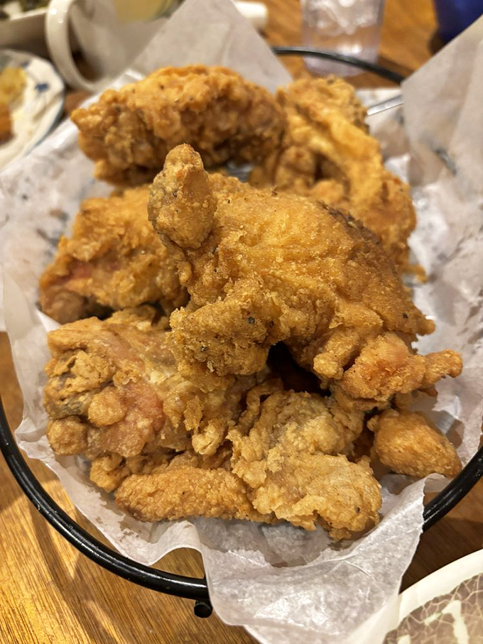 Golden-brown perfection that makes Colonel Sanders weep with envy. This skillet-fried chicken's crackling skin gives way to juicy meat that's worth every napkin.